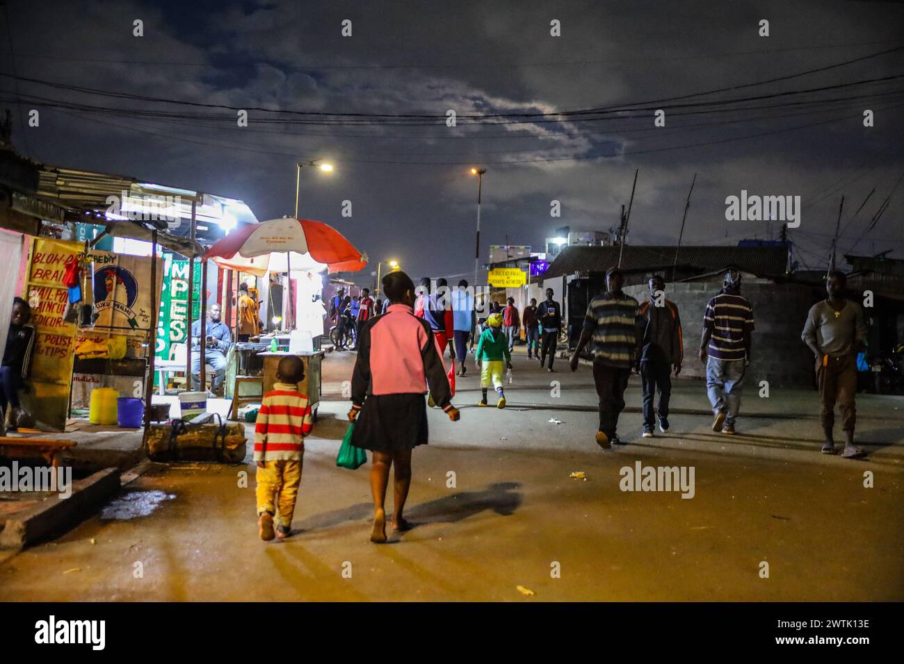 Residents walk back home late in the evening past the busy streets in ...