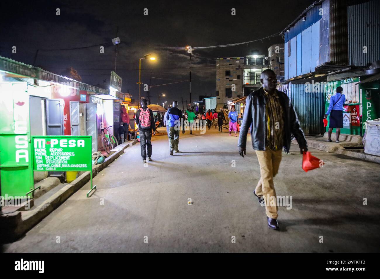 Residents walk back home late in the evening past the busy streets in ...