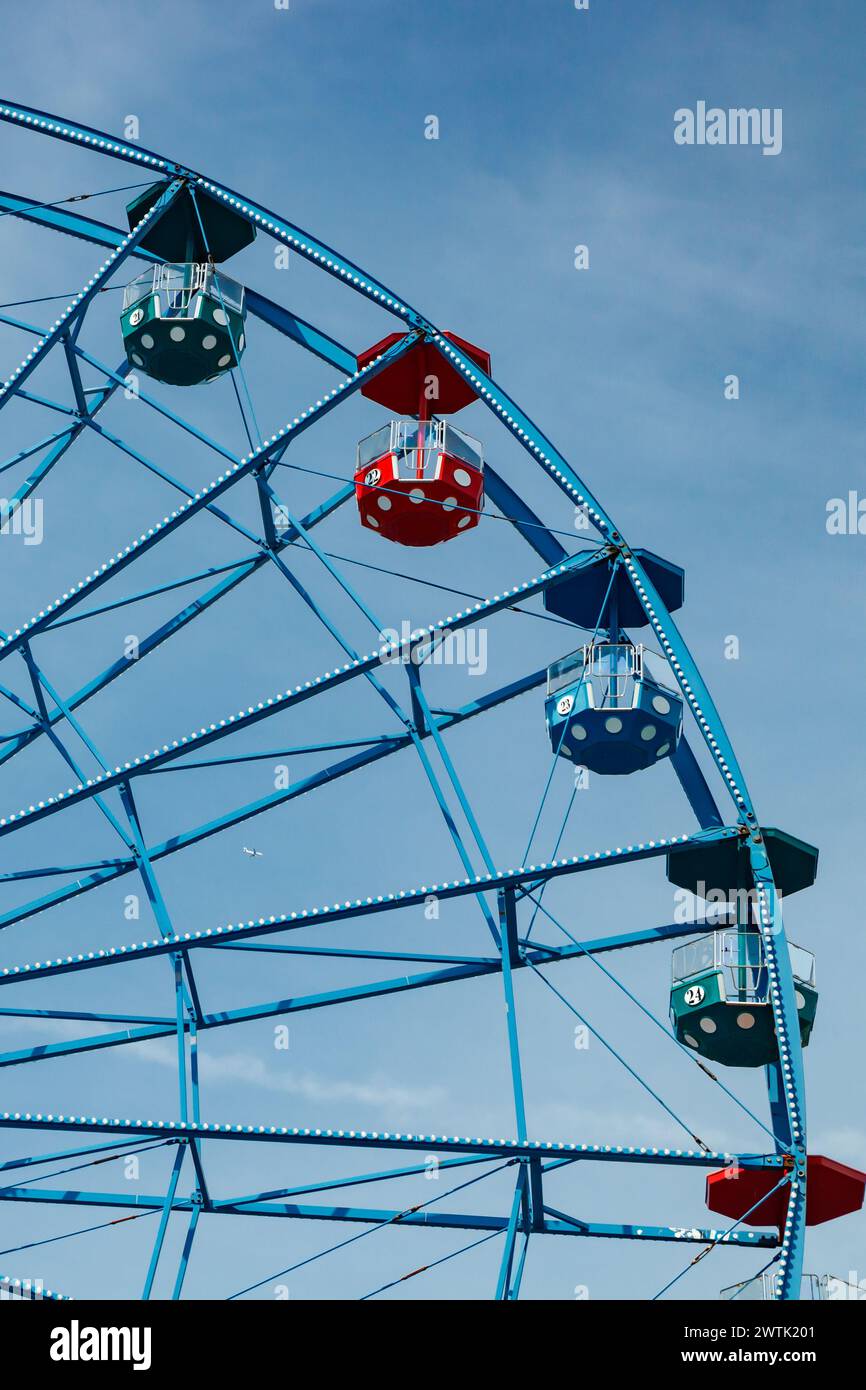 Colorful ride ferris wheel in motion in amusement park on sky ...