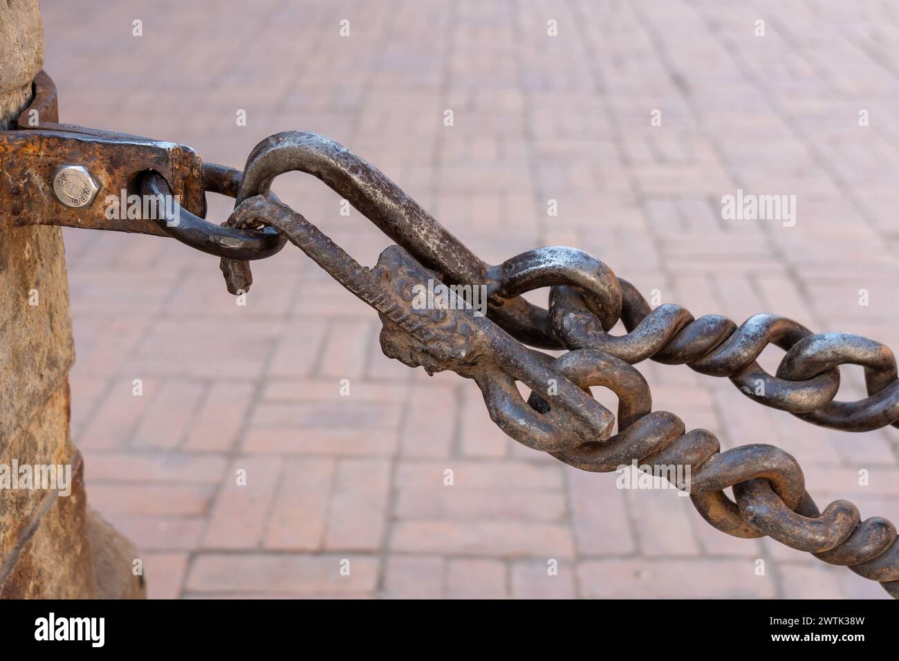 A Wrought Iron Chain Hooked onto a stone pillar Stock Photo - Alamy