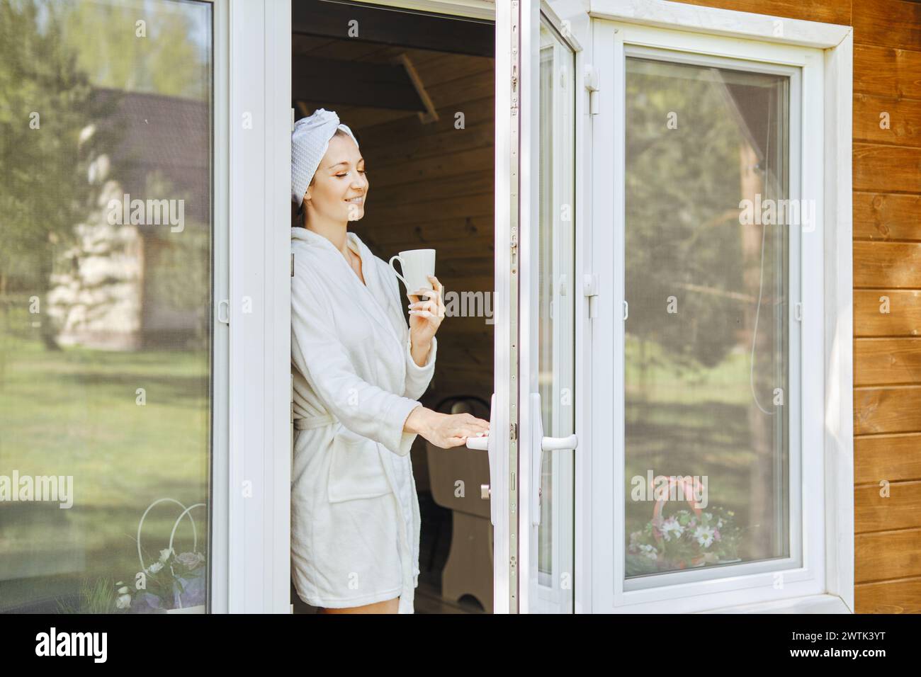 Woman in white bathrobe opens hi-res stock photography and images - Alamy