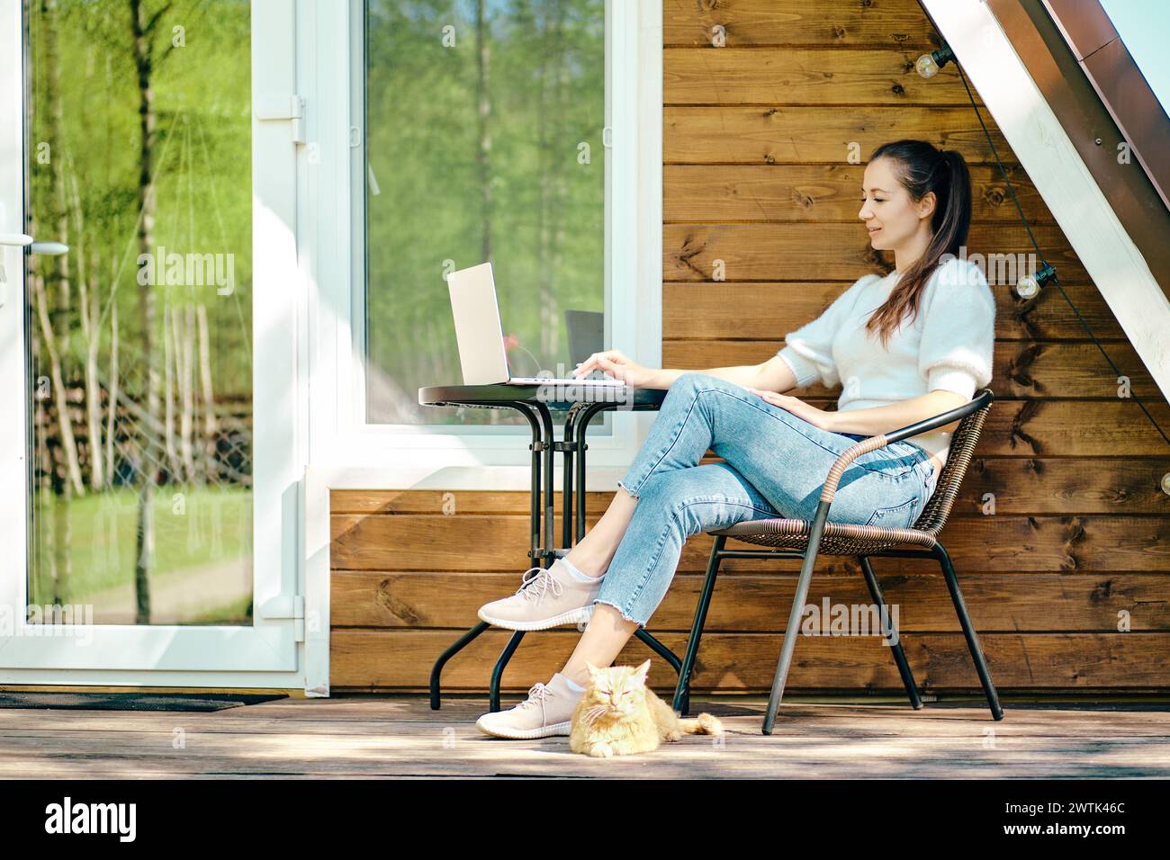 Woman sitting in log cabin hi-res stock photography and images - Alamy