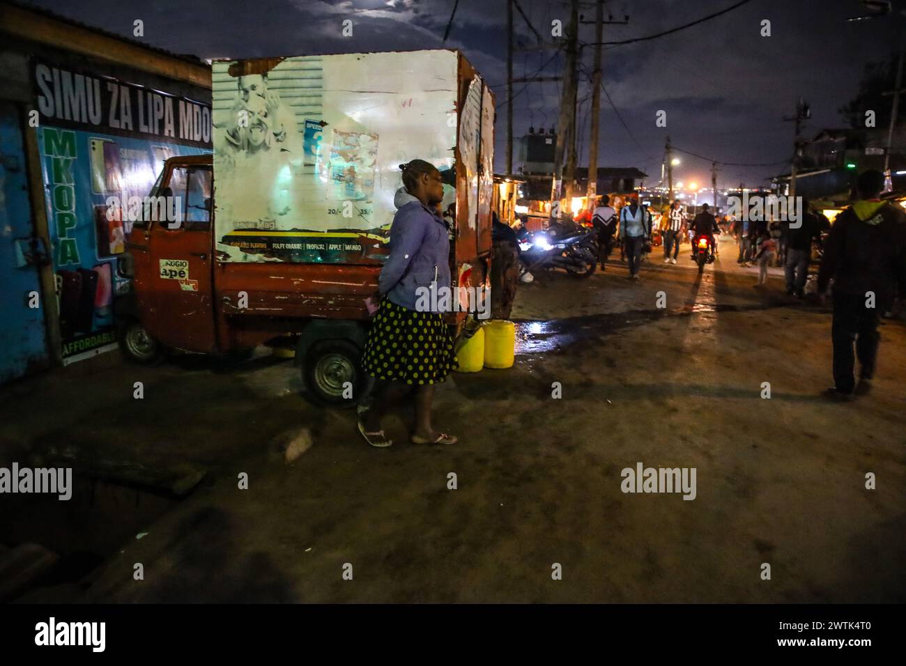 Residents walk back home late in the evening past the busy streets in ...