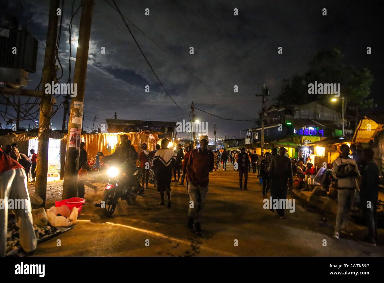 Residents walk back home late in the evening past the busy streets in ...