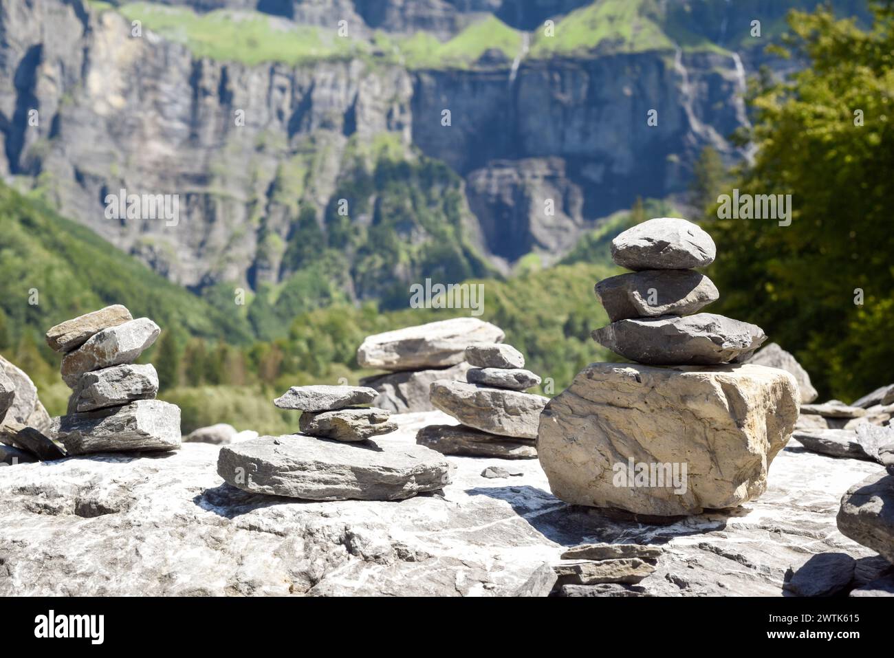 Stack of balancing rocks symbolising peace and mindfulness over a lush ...