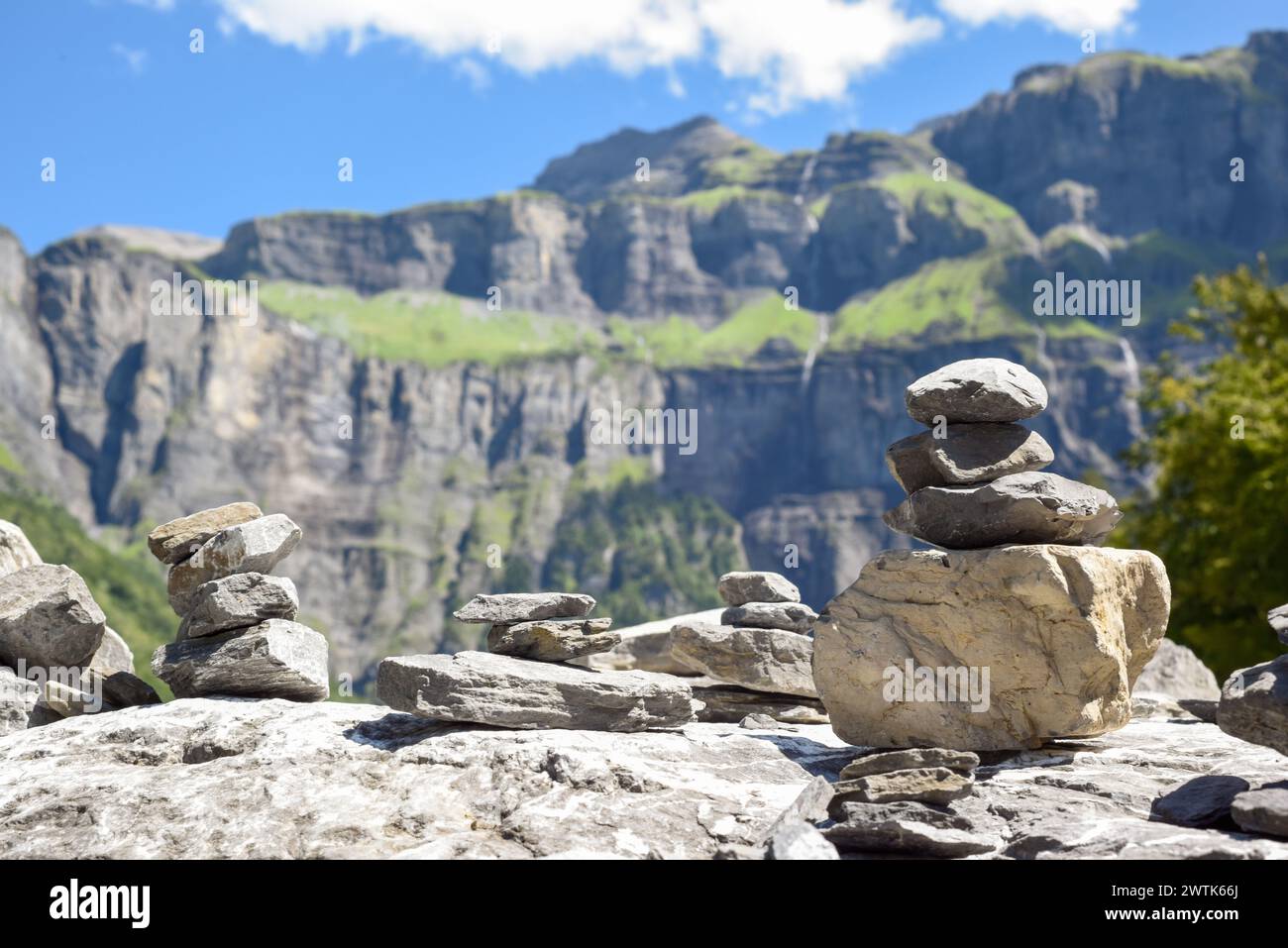 Stack of balancing rocks symbolising peace and mindfulness over a lush ...