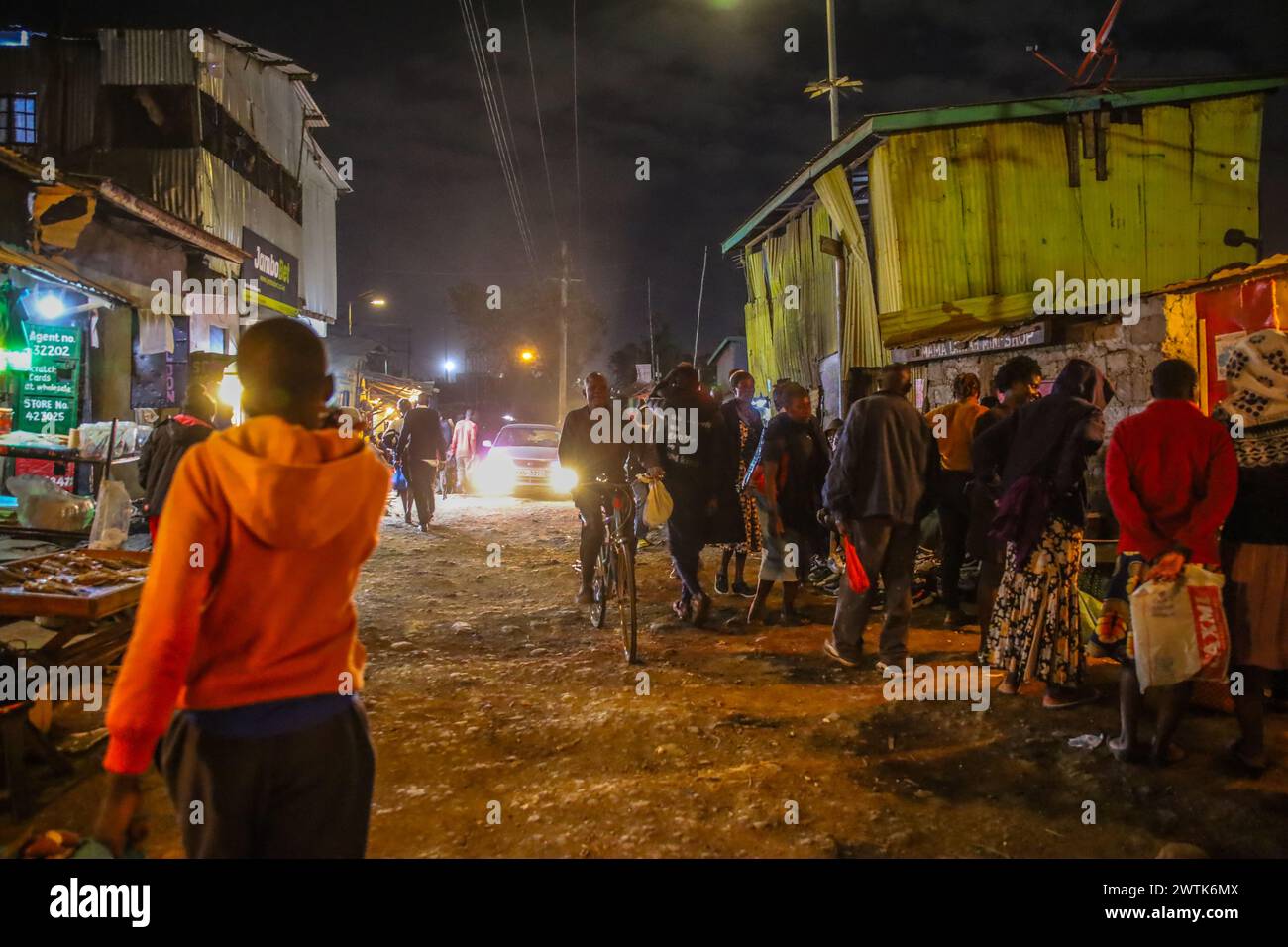 Residents walk back home late in the evening past the busy streets in ...