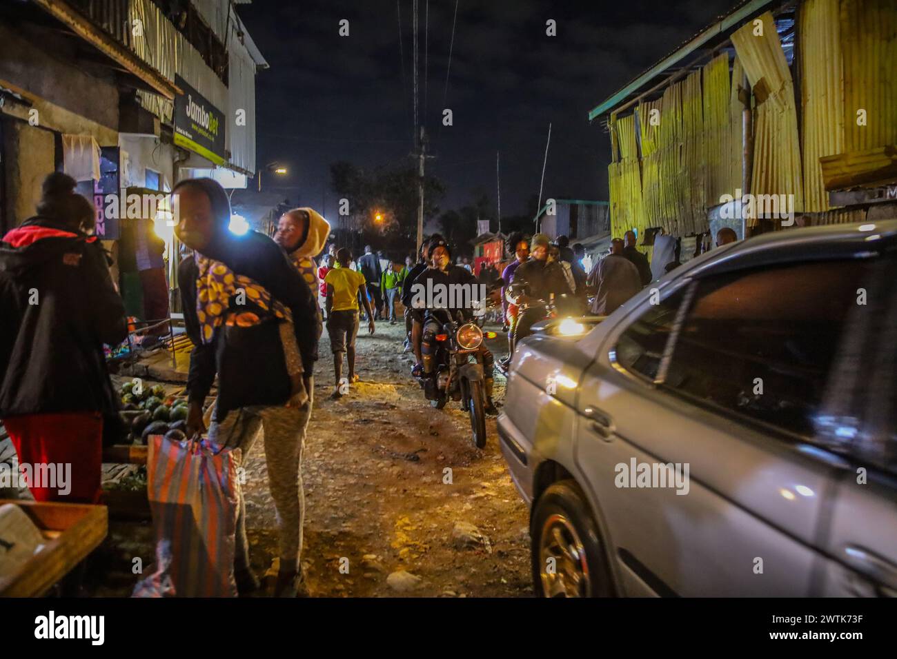 Residents walk back home late in the evening past the busy streets in ...