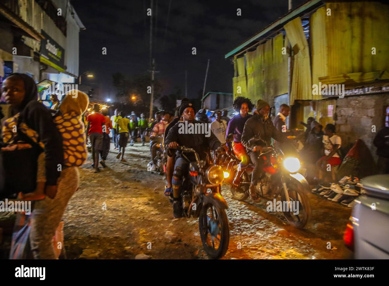 Residents walk back home late in the evening past the busy streets in ...