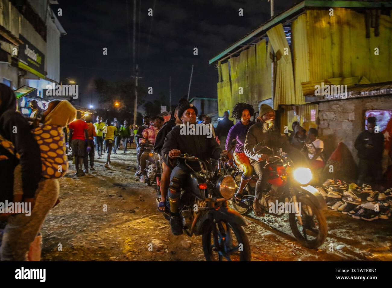 Residents walk back home late in the evening past the busy streets in ...
