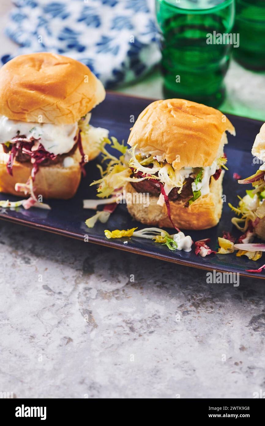 This April 2019 image shows a recipe for chipotle sliders with a ...