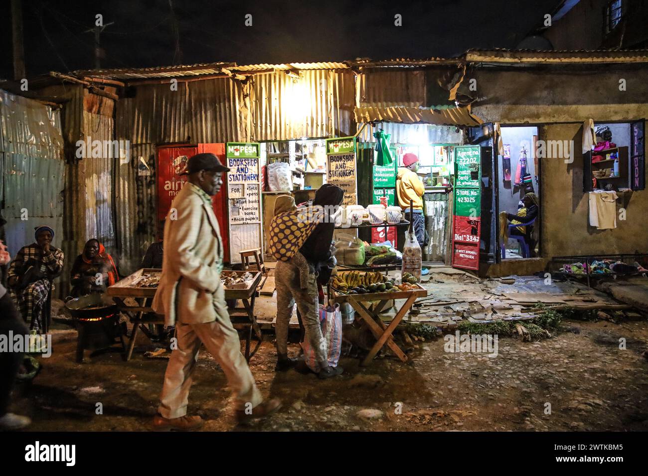 Residents walk back home late in the evening past the busy streets in ...