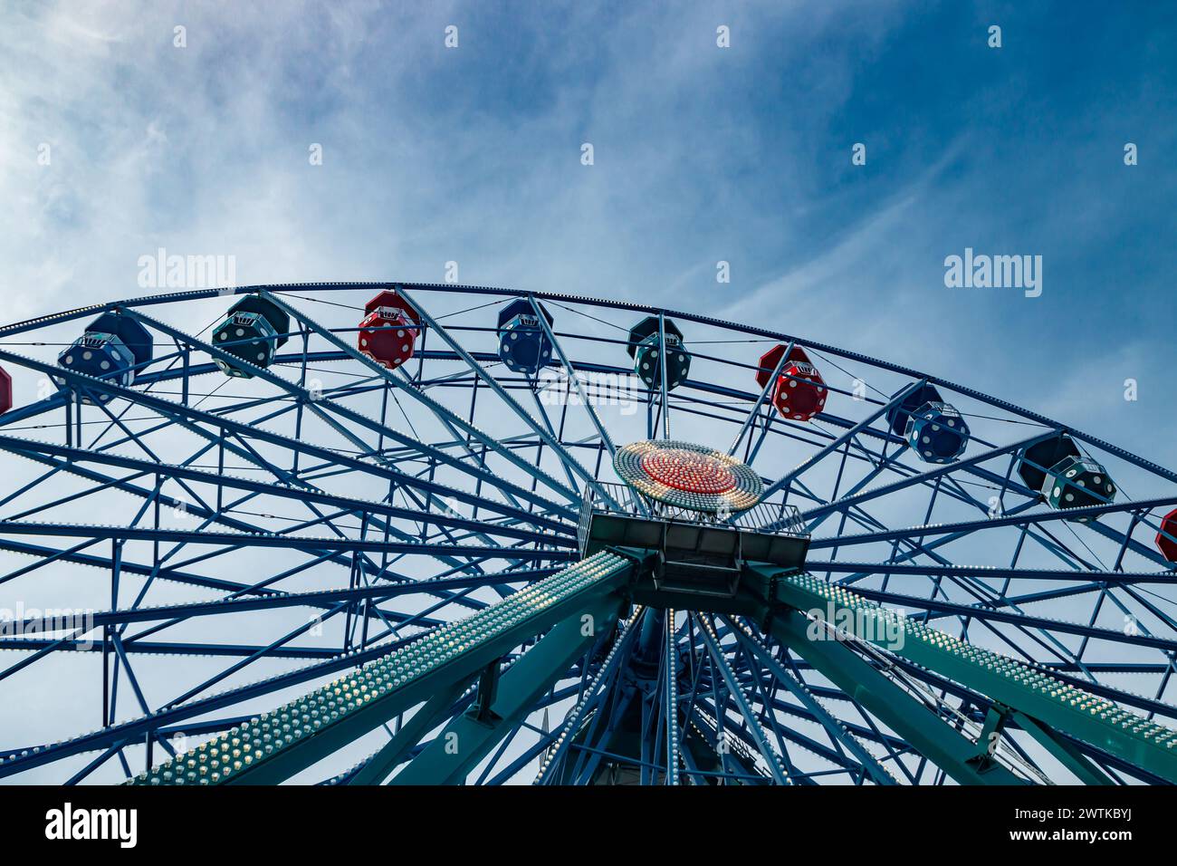 Colorful ride ferris wheel in motion in amusement park on sky ...