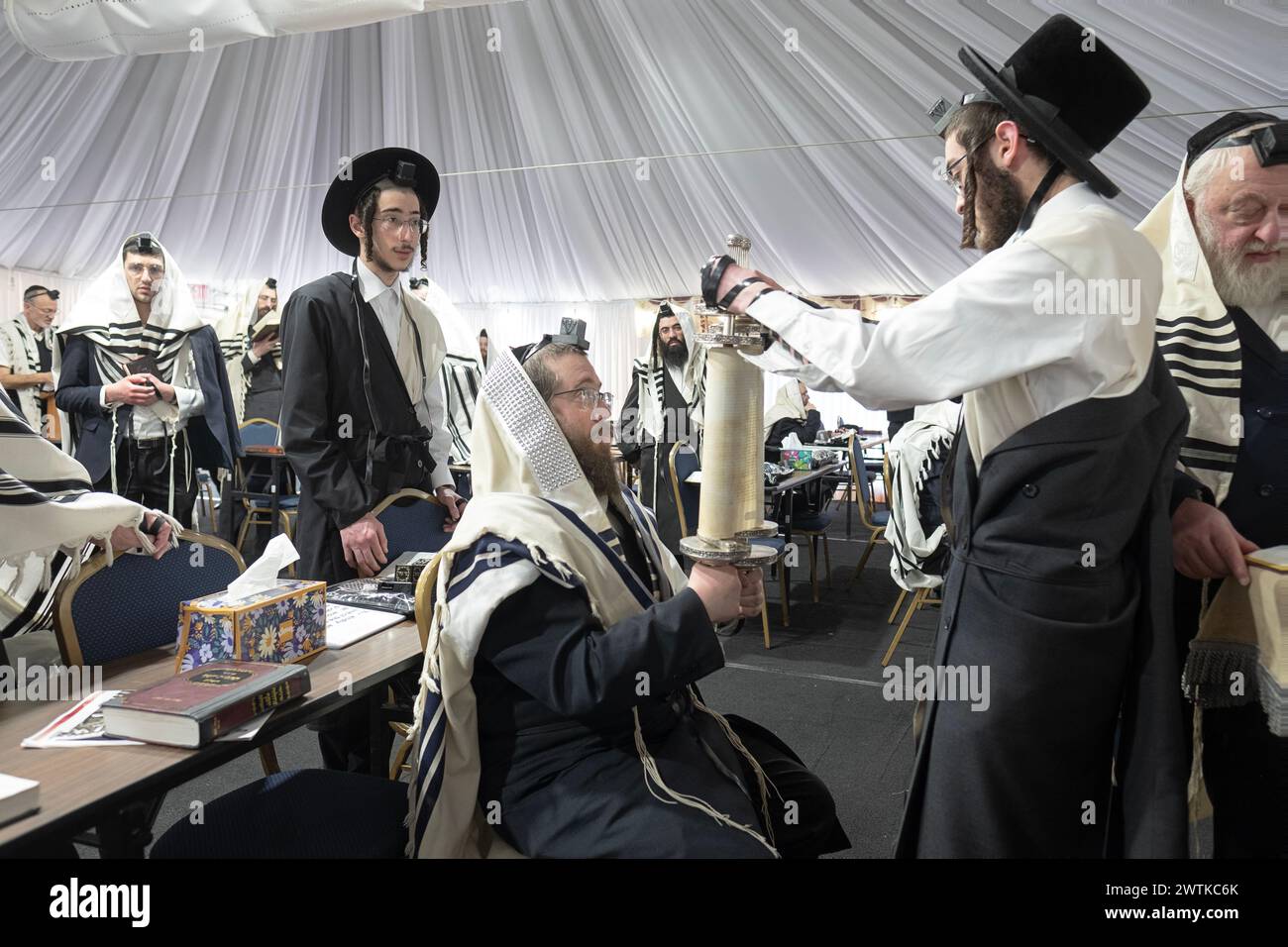 After a reading & before its returned to the Holy Ark, a Torah scroll ...