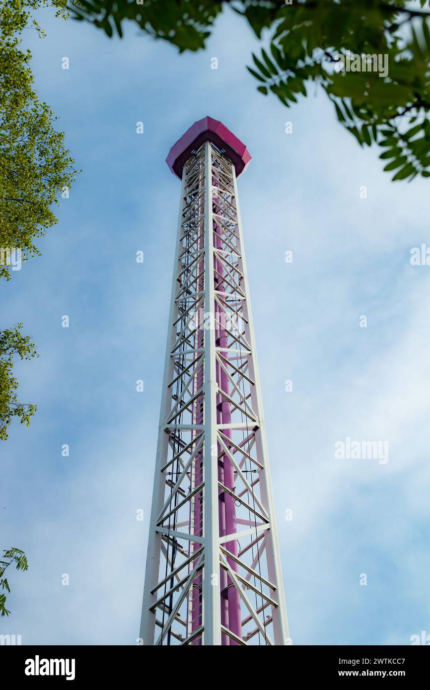 Ride tower in amusement park on blue sky background Stock Photo - Alamy