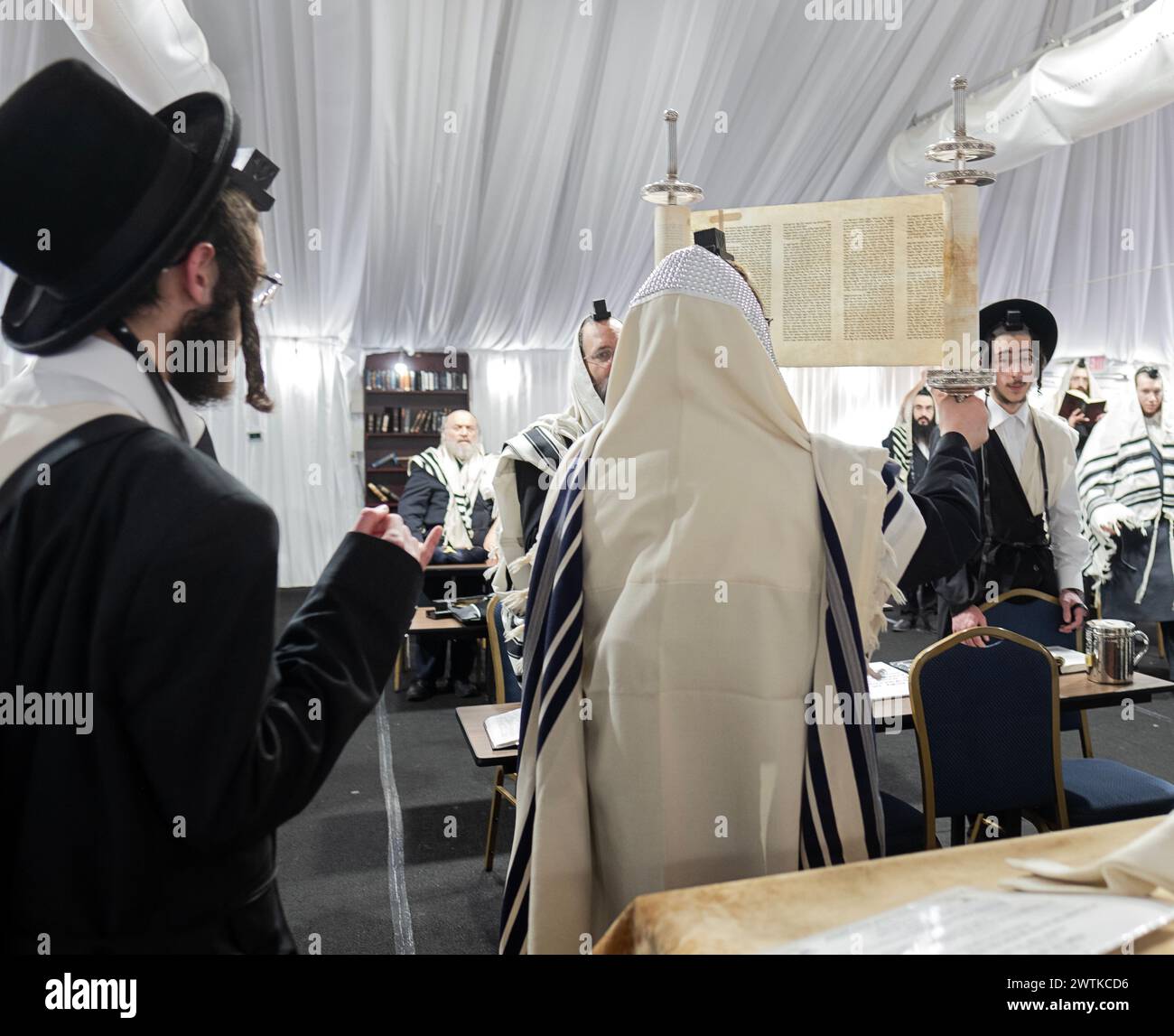 After a weekday reading, a Torah is lifted and show to the congregation ...