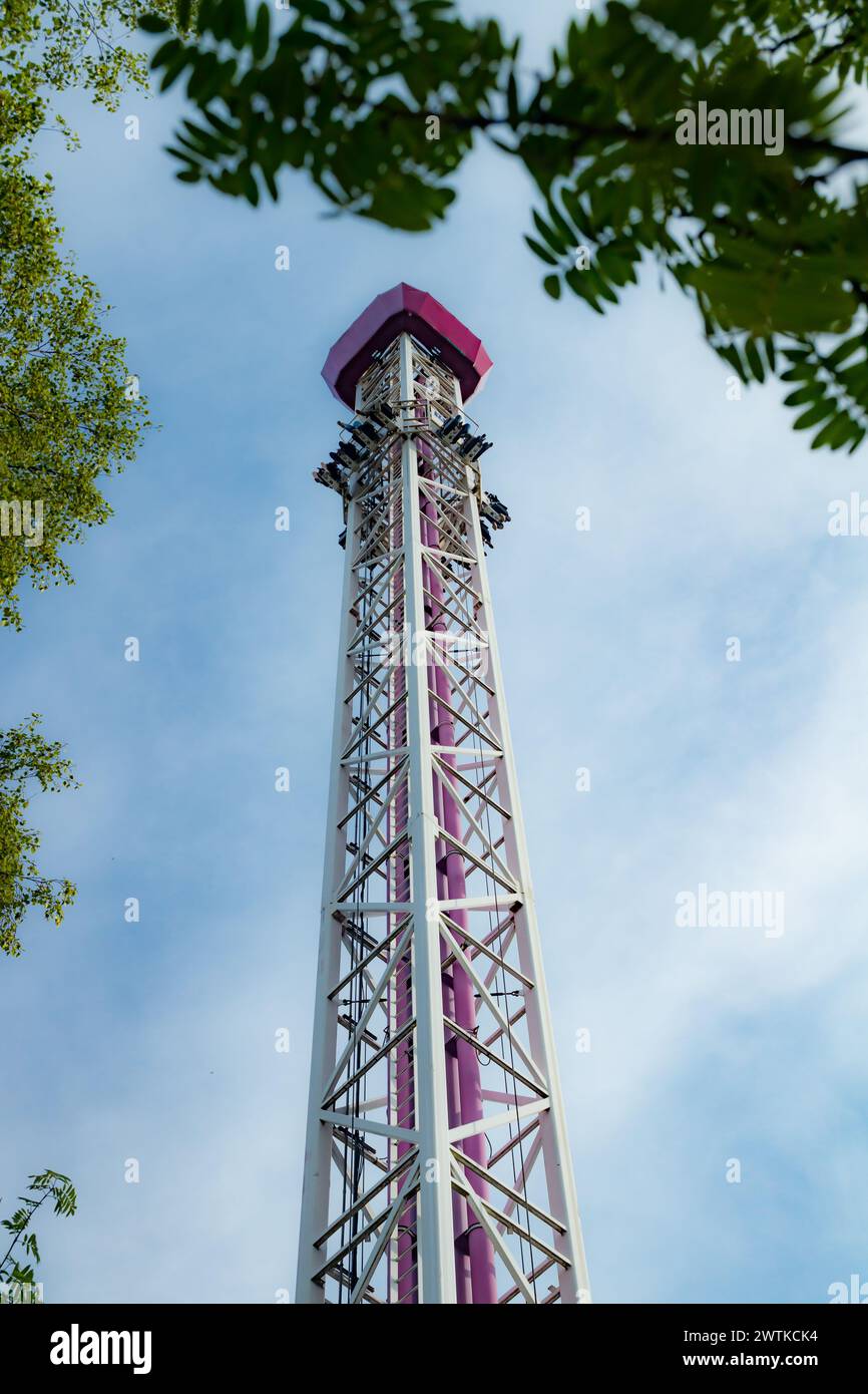 Ride tower in motion in amusement park on blue sky background Stock ...