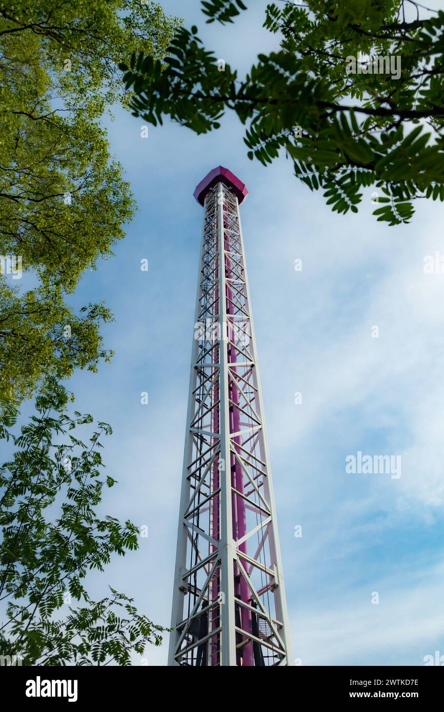 Ride tower in amusement park on blue sky background Stock Photo - Alamy