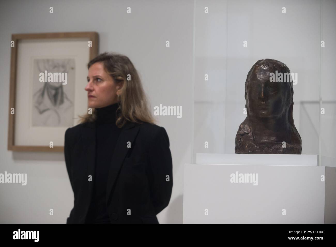 Malaga, Spain. 18th Mar, 2024. A worker stands next to a sculpture ...