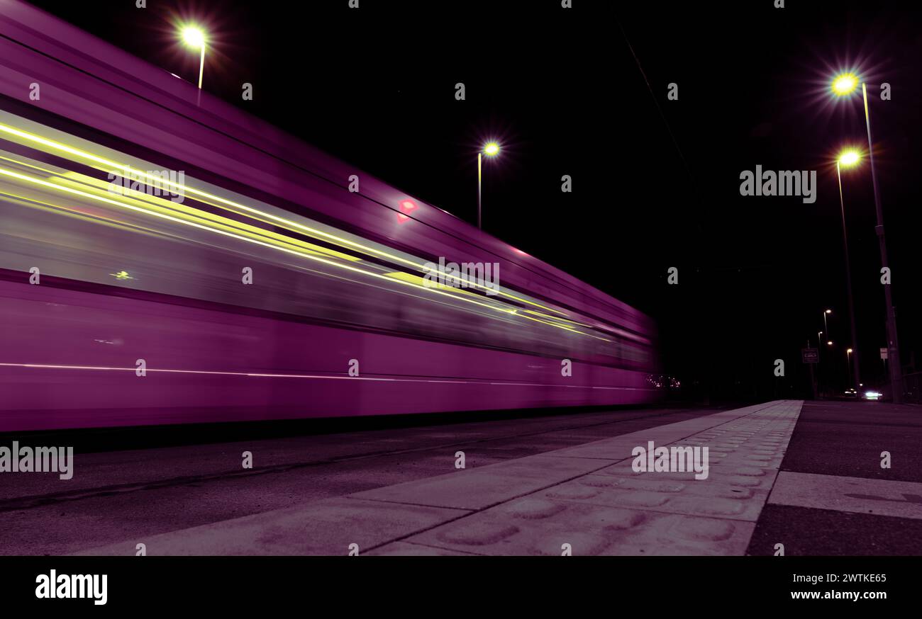 Train moving past quickly at night Stock Photo - Alamy