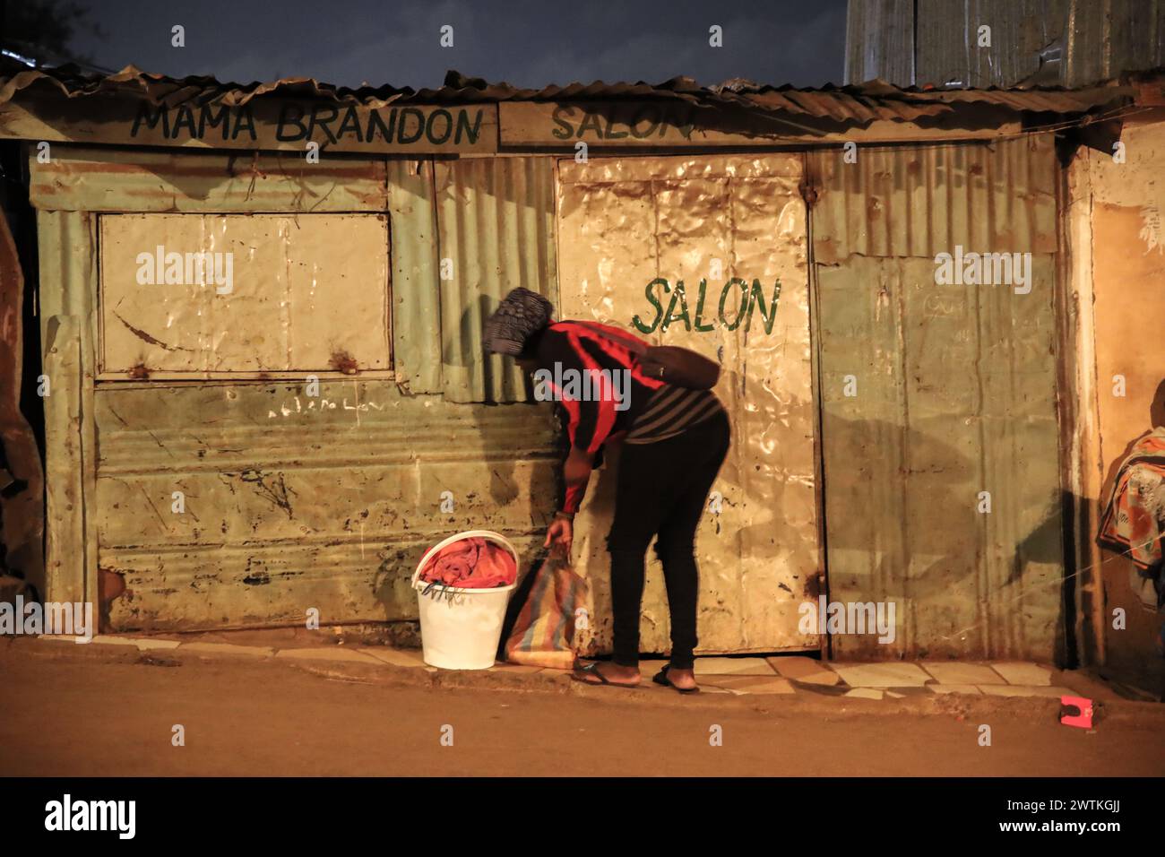 A saloonist at mama brandon salon is closing down her shop in Kibera ...