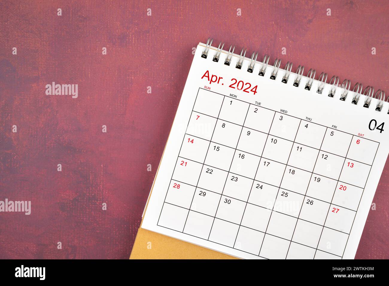 April 2024 desk calendar on red color background Stock Photo - Alamy