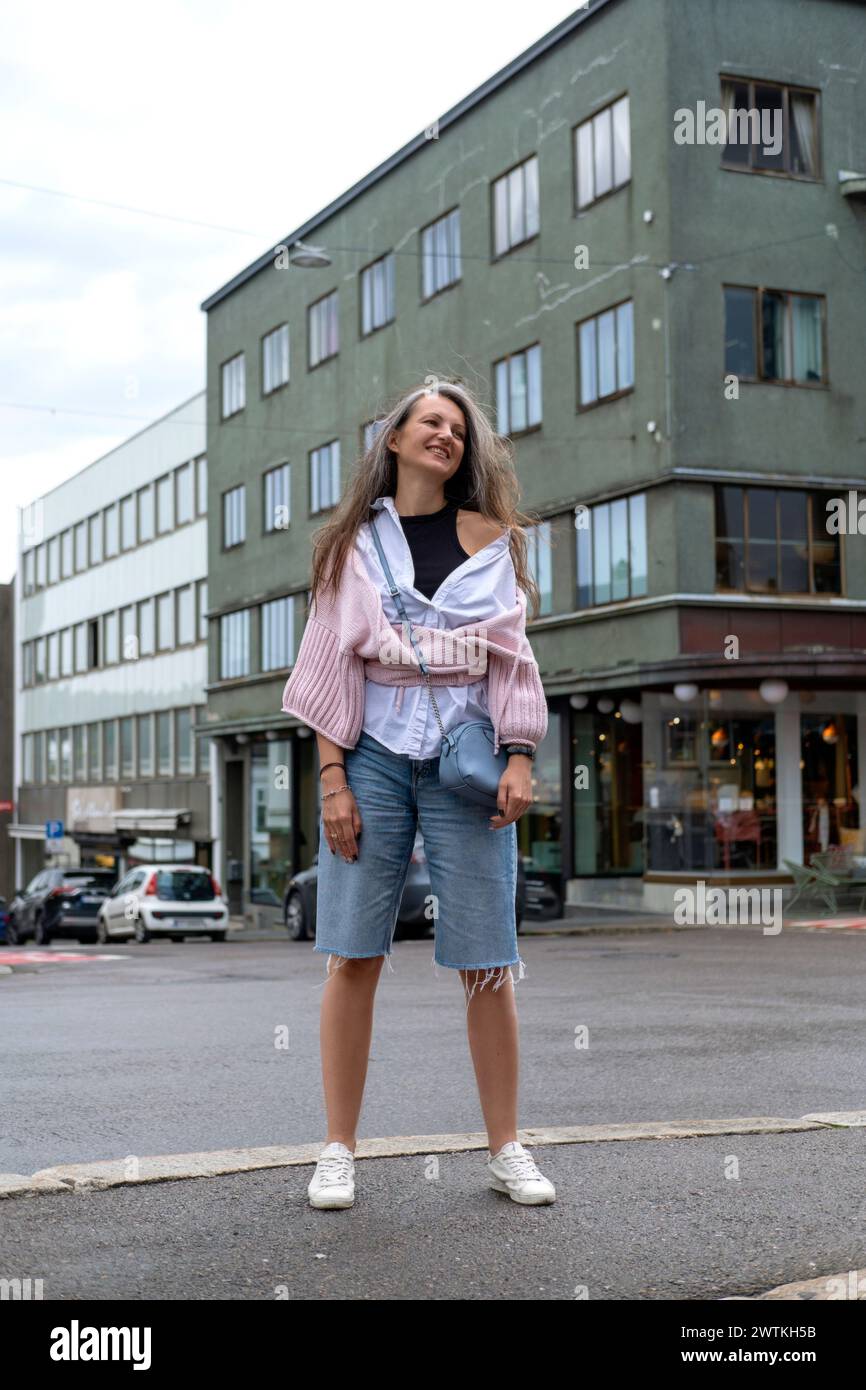 A stylishly dressed modern adult woman walks around the city Stock ...