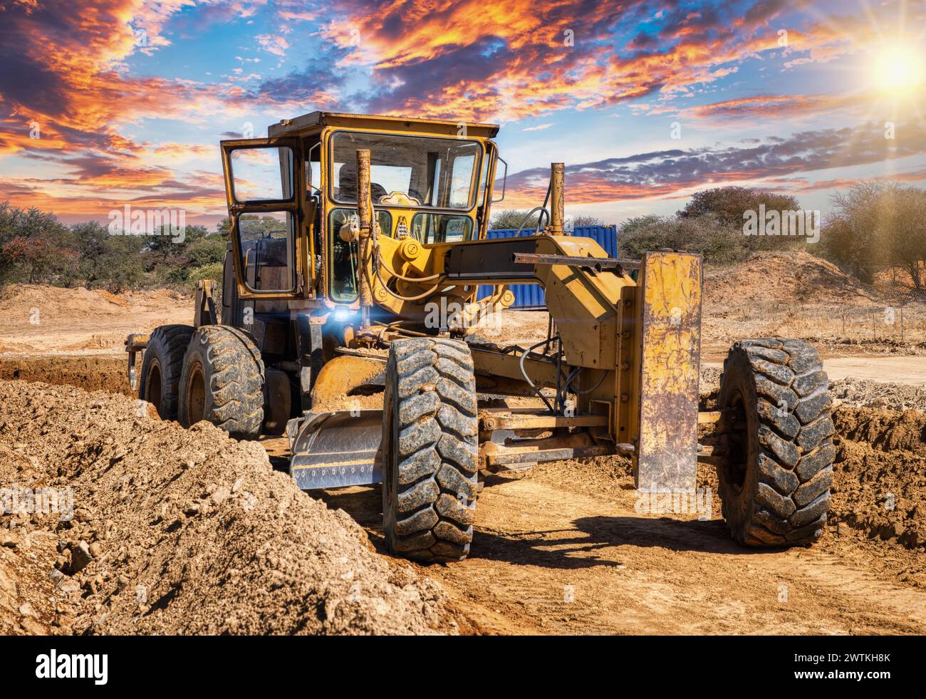 yellow grader digging the earth on a construction site at a diamond ...