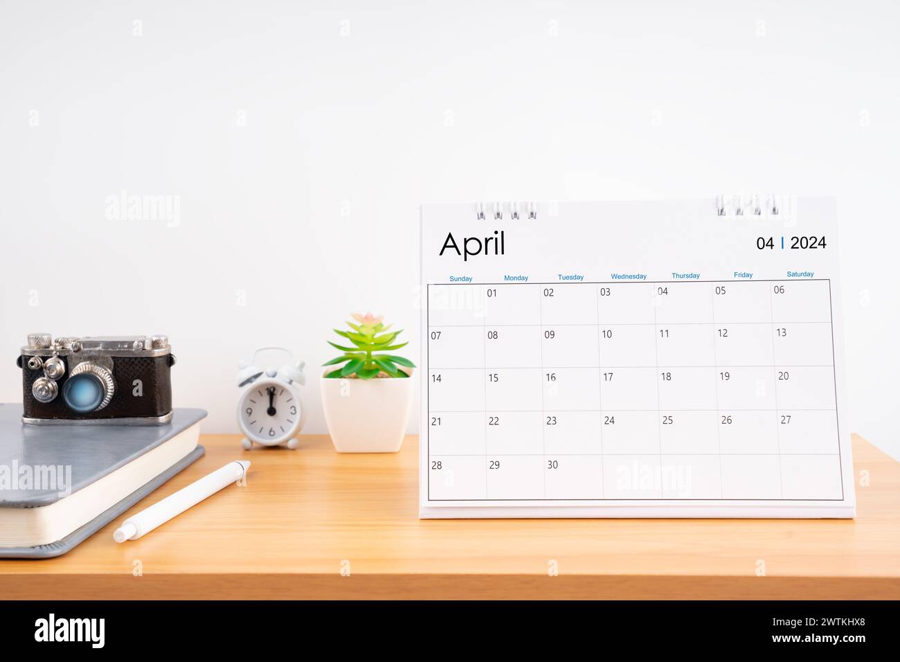 Desktop Calendar for April 2024 year and vintage camera with diary for ...