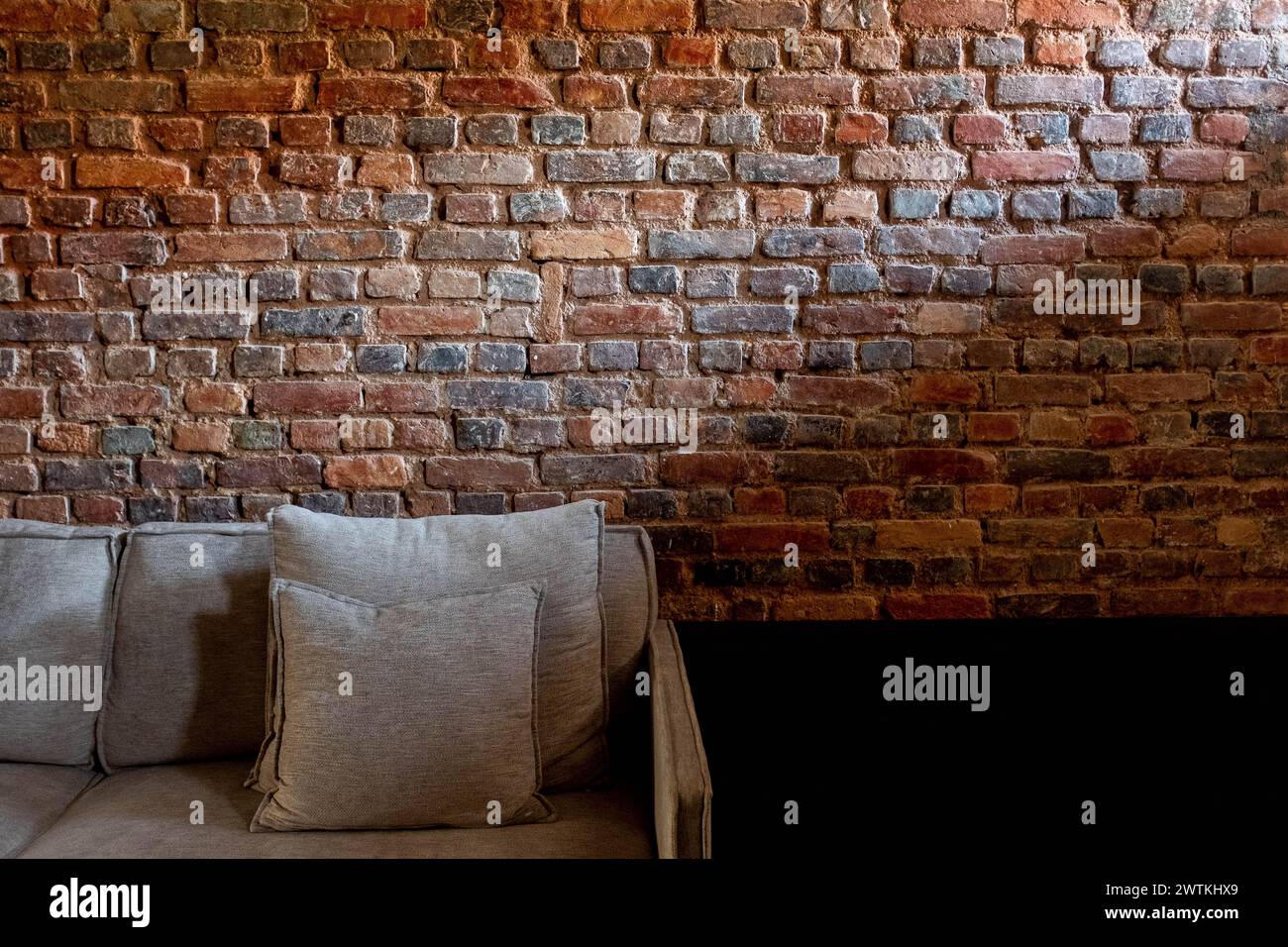 Dimly lit room with part of a seat cushion with red open bricks Stock ...