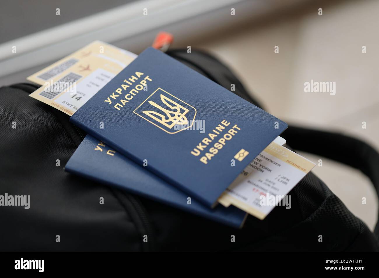 Two ukrainian biometrical passports with air flight tickets on black ...