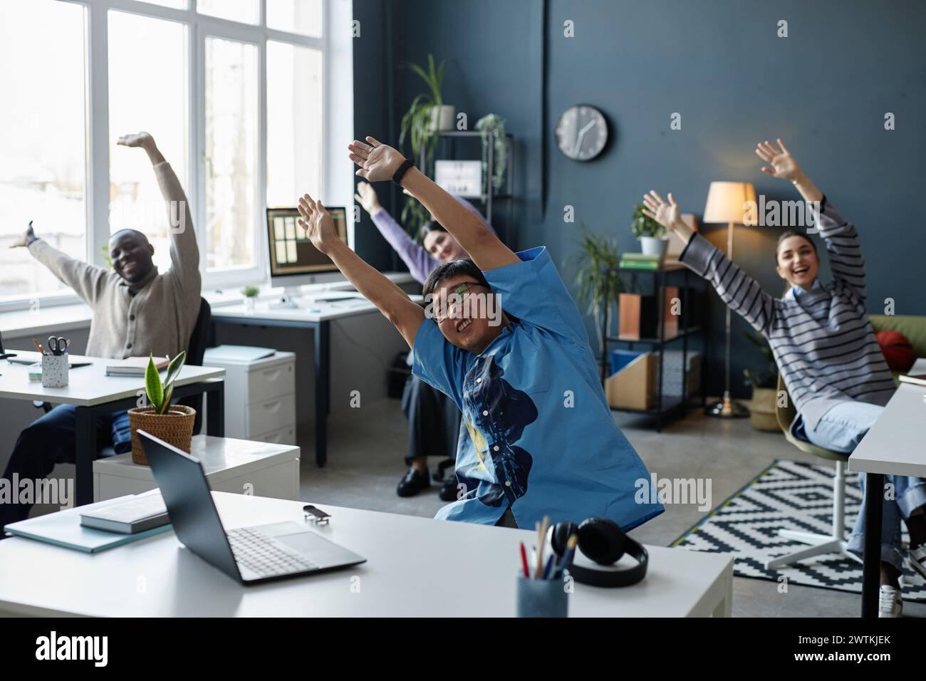 Diverse group of people working together and enjoying stretching ...