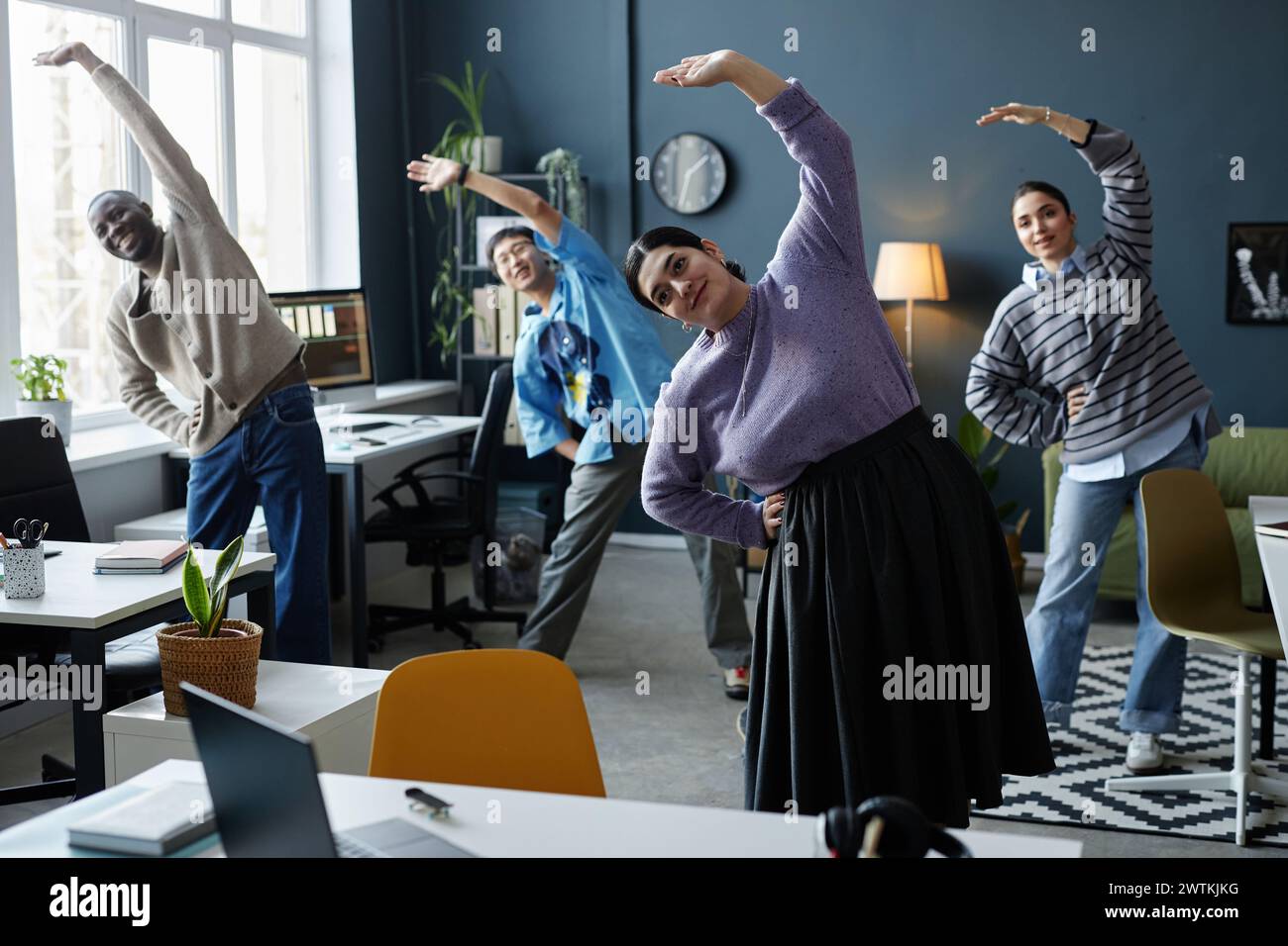 Multiethnic group of people enjoying stretching exercises starting ...