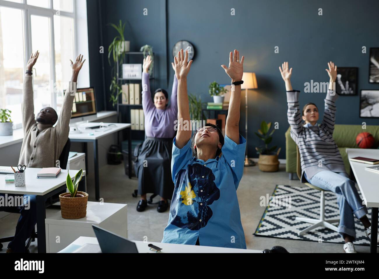 Multiethnic group of people enjoying stretching and breathing exercises ...