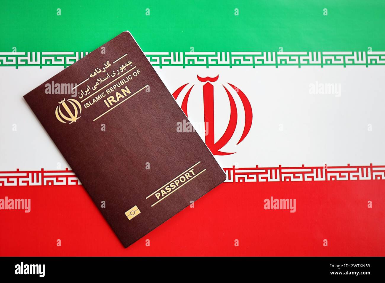 Red Islamic Republic of Iran passport on national flag background close ...