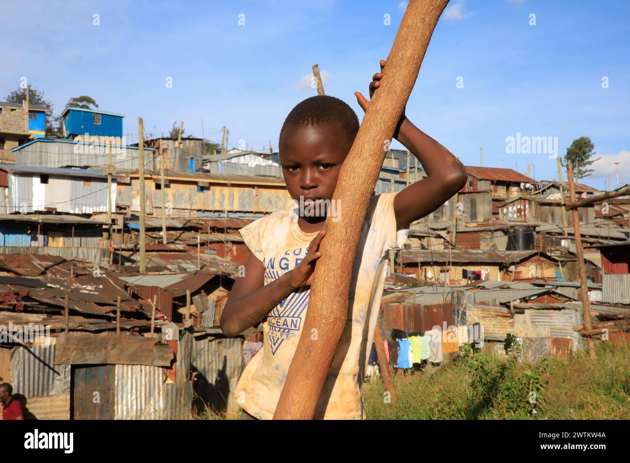 A young boy is posed for a photo at a field in Kibera Slum. Kibera, the ...