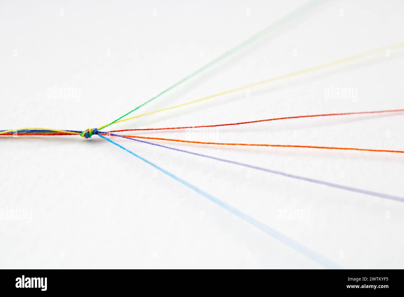 Threads of different colors that join together in a knot and take ...