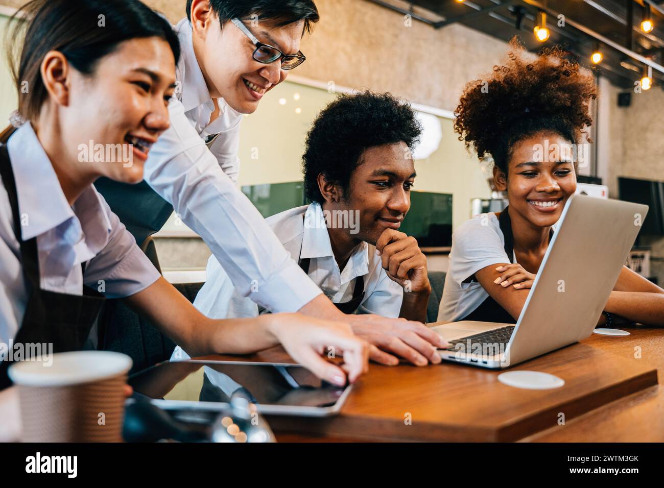 Coffee shop owner and young business team collaborate in project ...