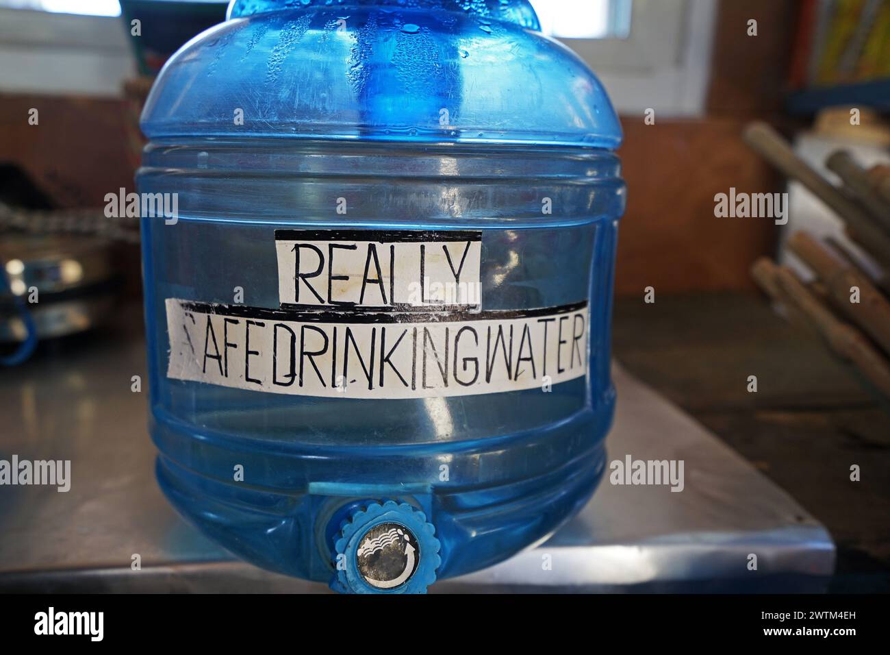 Close up Plastic tap water tank container with text 'REALLY SAFE ...