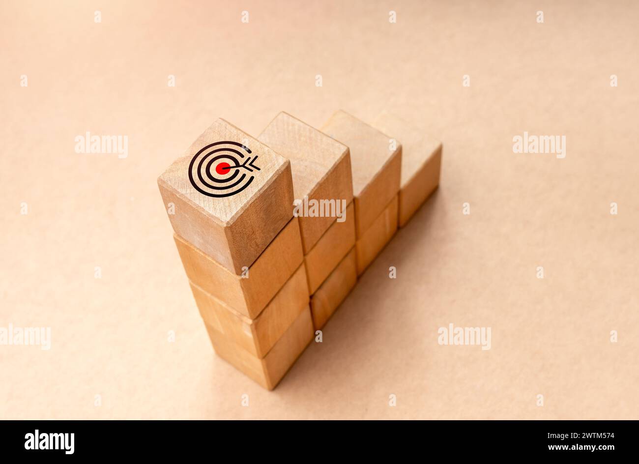 Target dart icon on top of wooden blocks graph steps on brown kraft ...