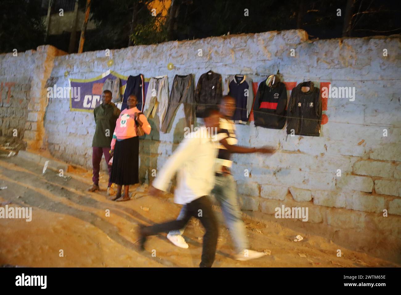 Residents walk back home late in the evening past the busy streets in ...