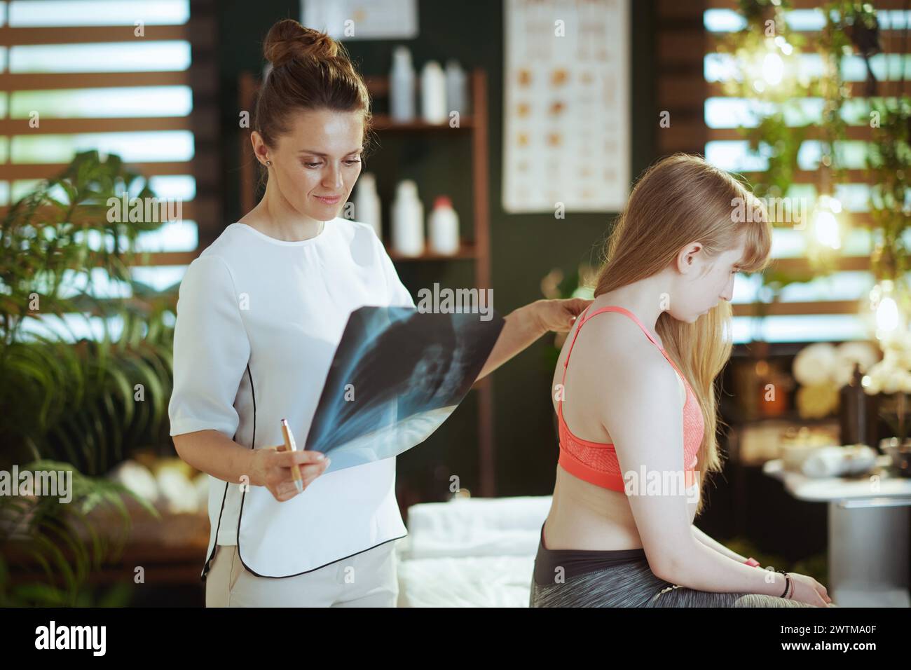 Healthcare Time Concerned Female Massage Therapist In Massage Cabinet
