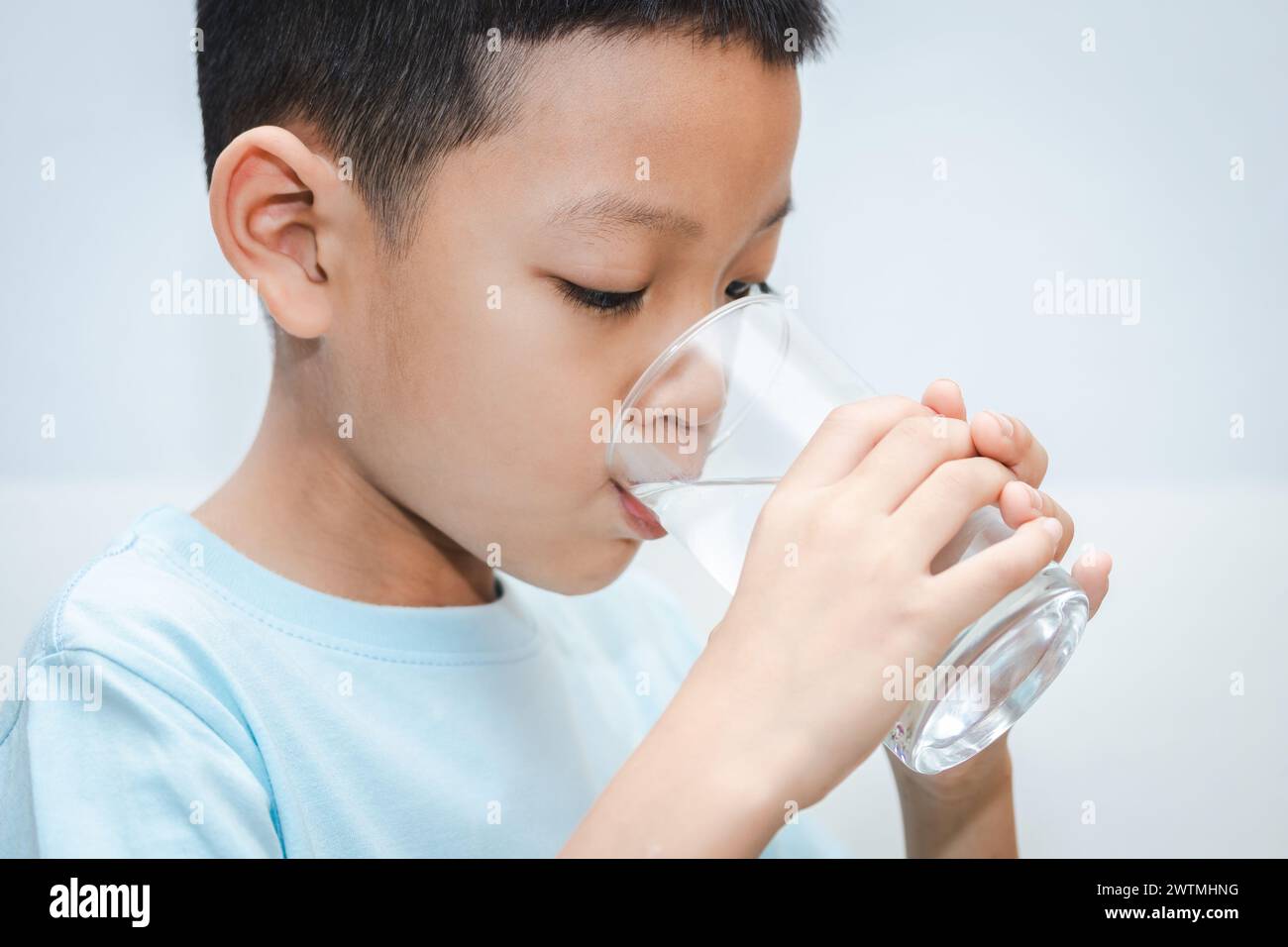 little Asian boy drinks water from a glass. shot of a child drinking a glass of cold water Stock ...