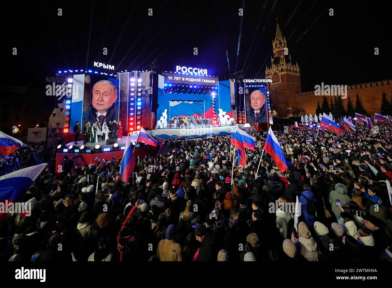 Russian President Vladimir Putin is seen on the screens as he attends a ...