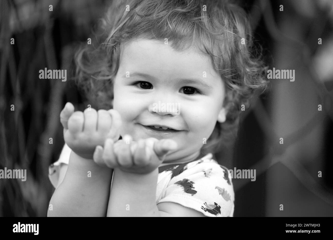 Portrait of a happy laughing baby child on playground. Close up ...