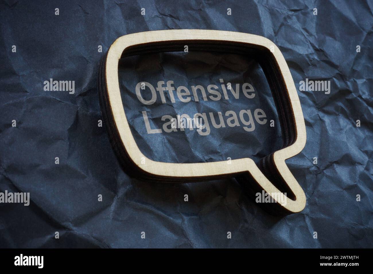 Offensive language concept. Speech bubble on crumpled paper Stock Photo ...