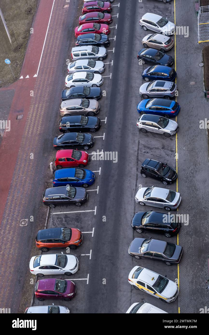 large parking lot for cars in front of a multi-storey residential ...