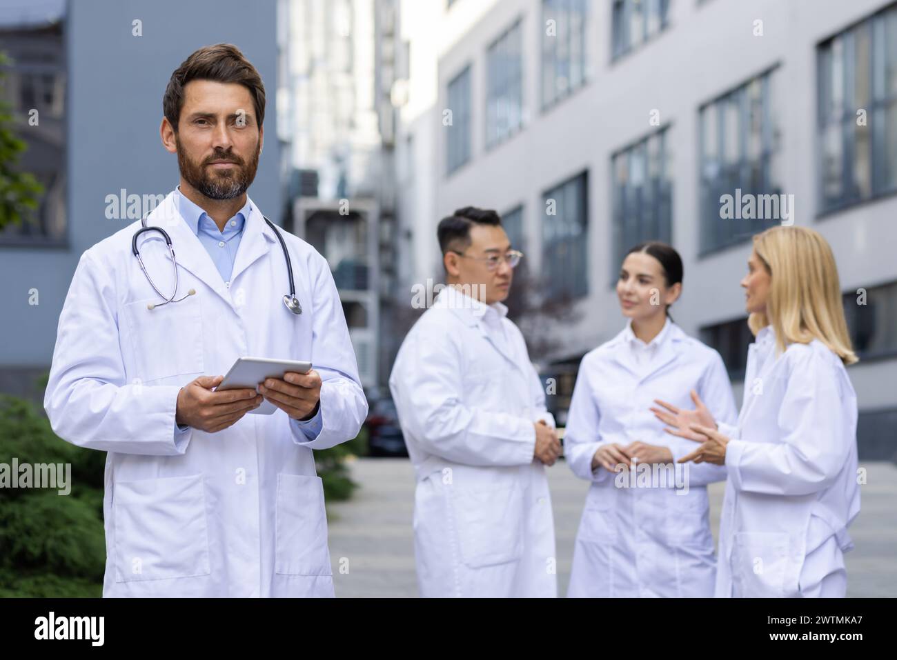 Experienced caucasian surgeon with stethoscope over neck standing with ...