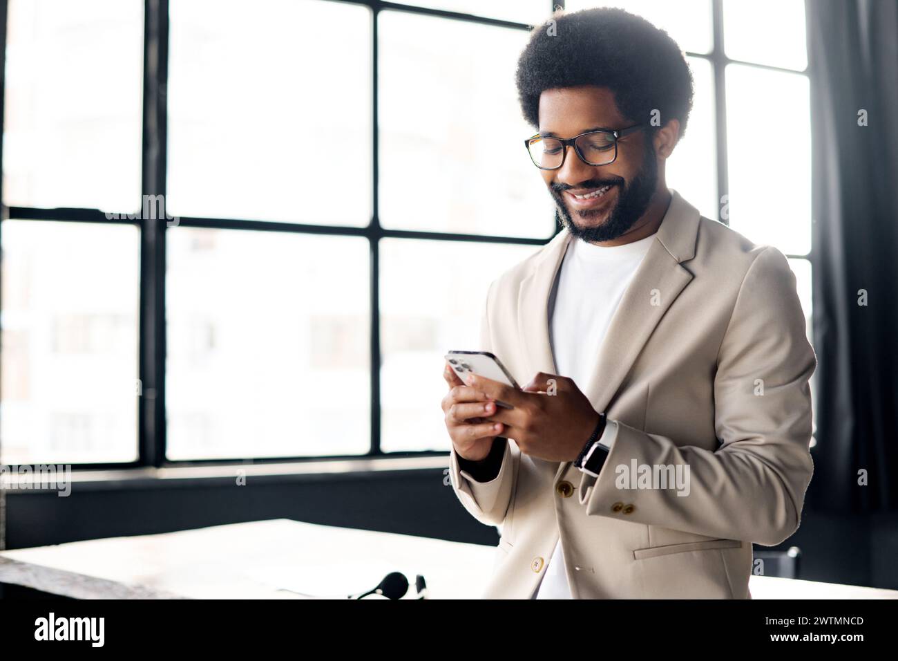 A modern Brazilian businessman in a light beige suit is smiling while ...