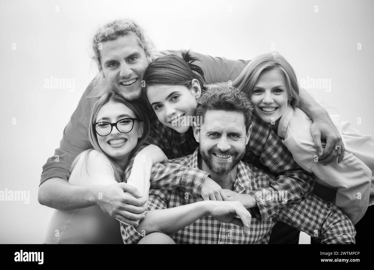 Smiling group of friends laughing. Group of friends embrace together ...